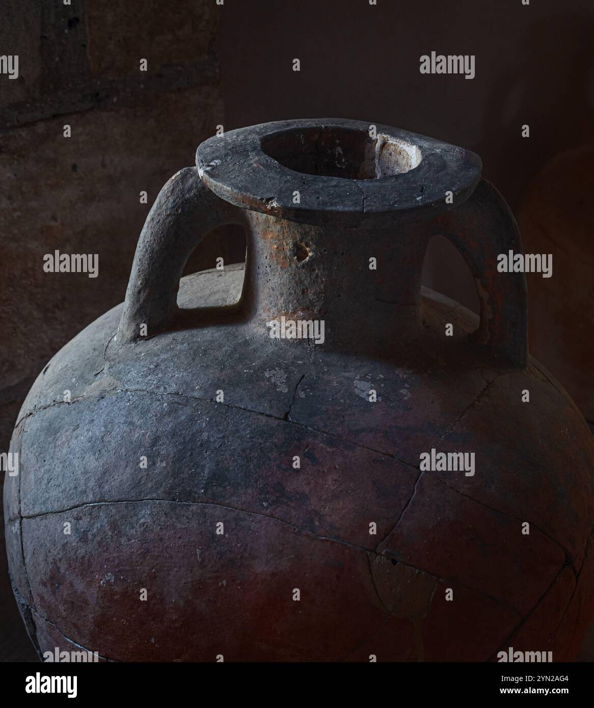 Broken clay pot isolated on a dark background. Ancient roman Clay ...