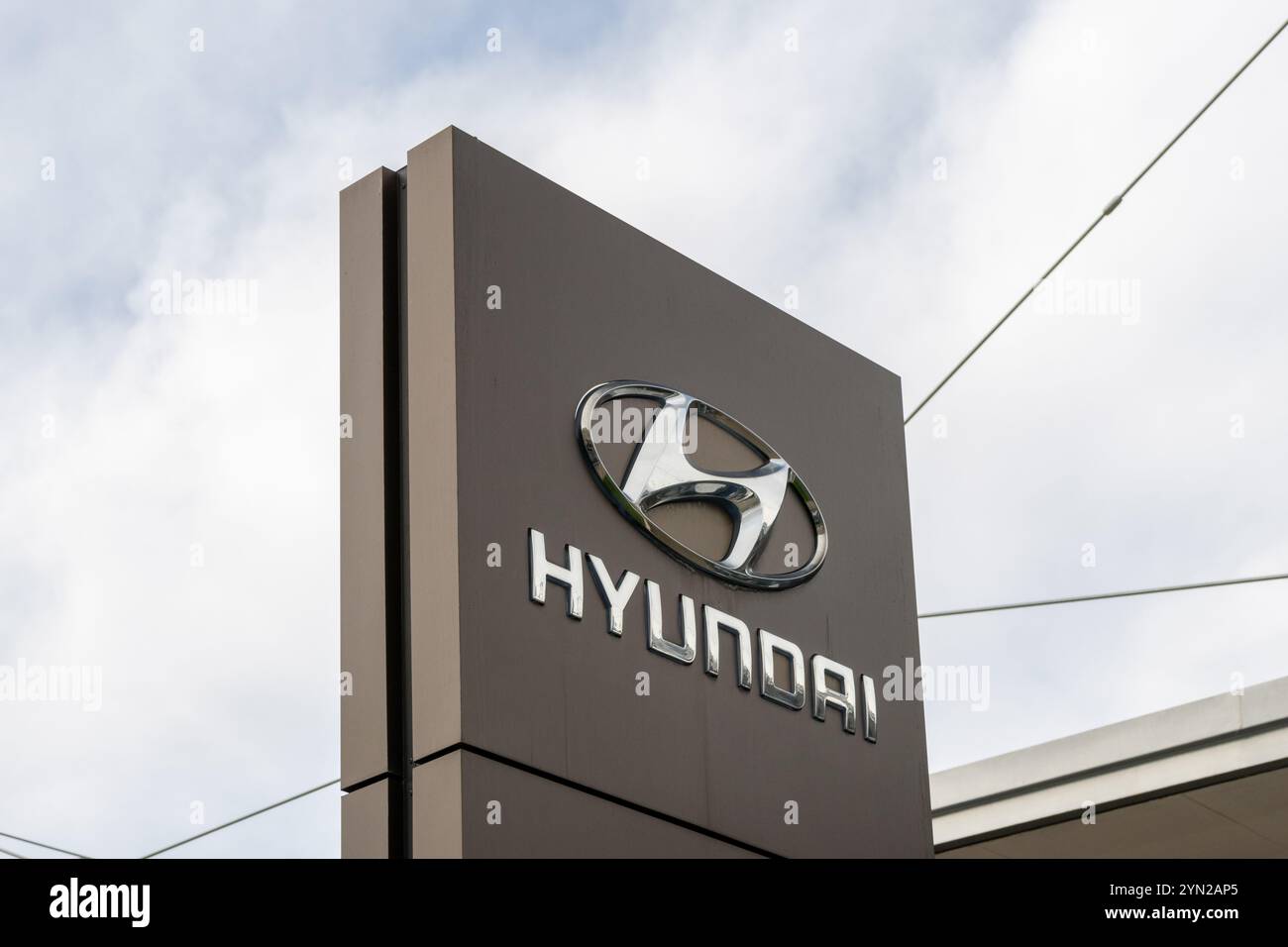 Hyundai motor company logo shining on a dealership building sign Stock ...