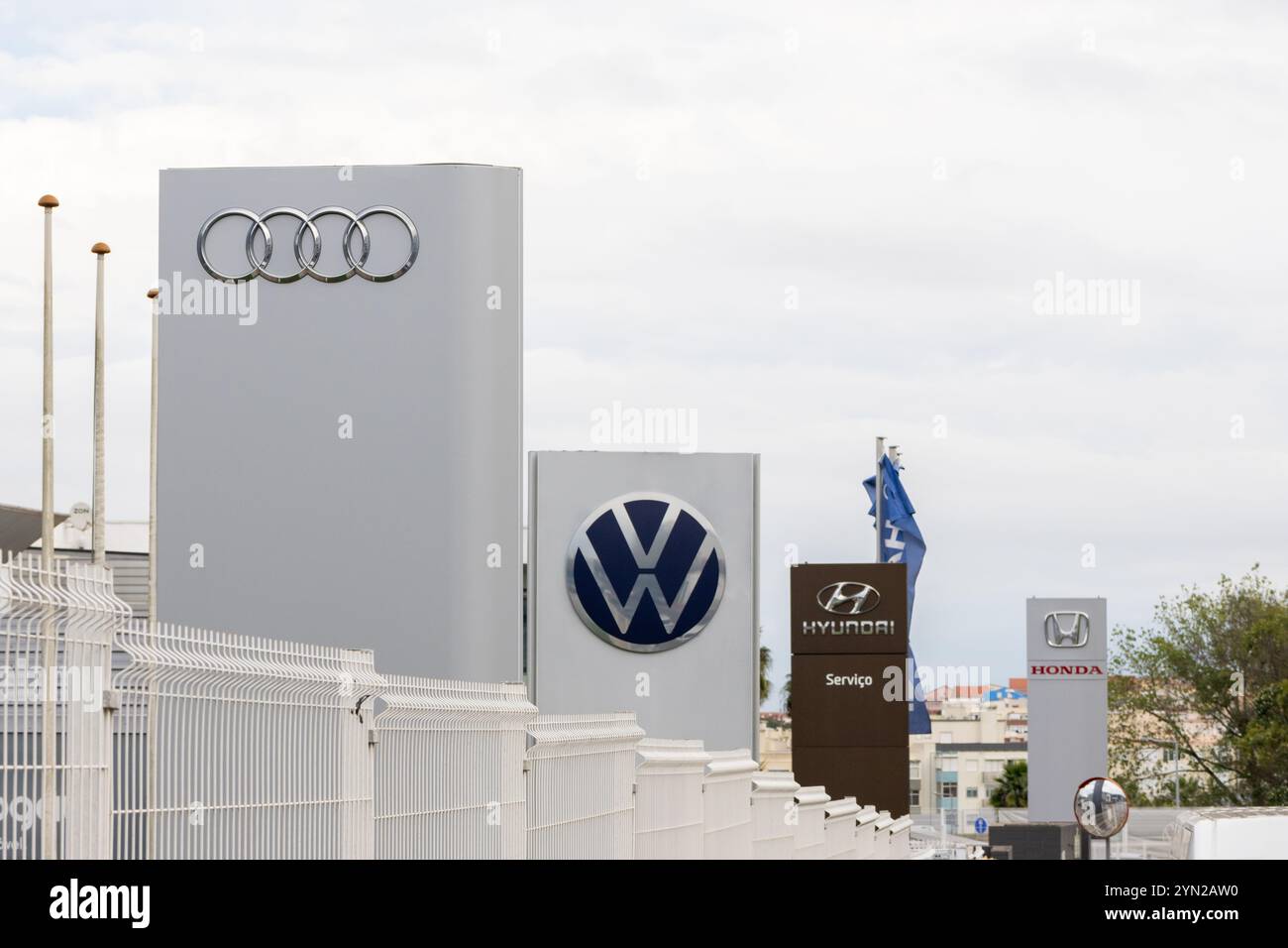 Four car brands logos on signs at dealership representing automotive ...