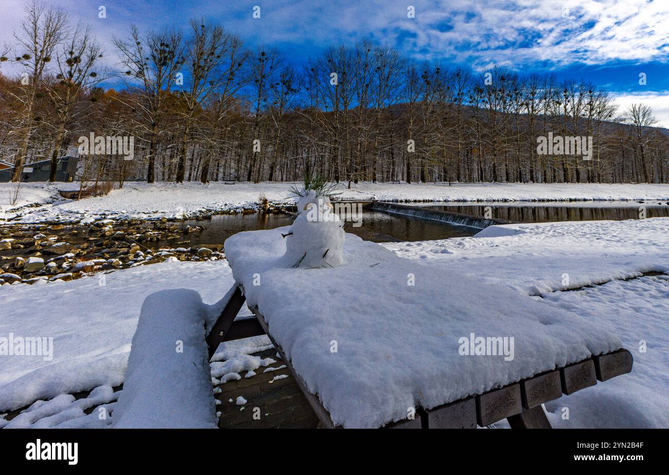 A walk along the river in the mountains, a small snowman made by ...