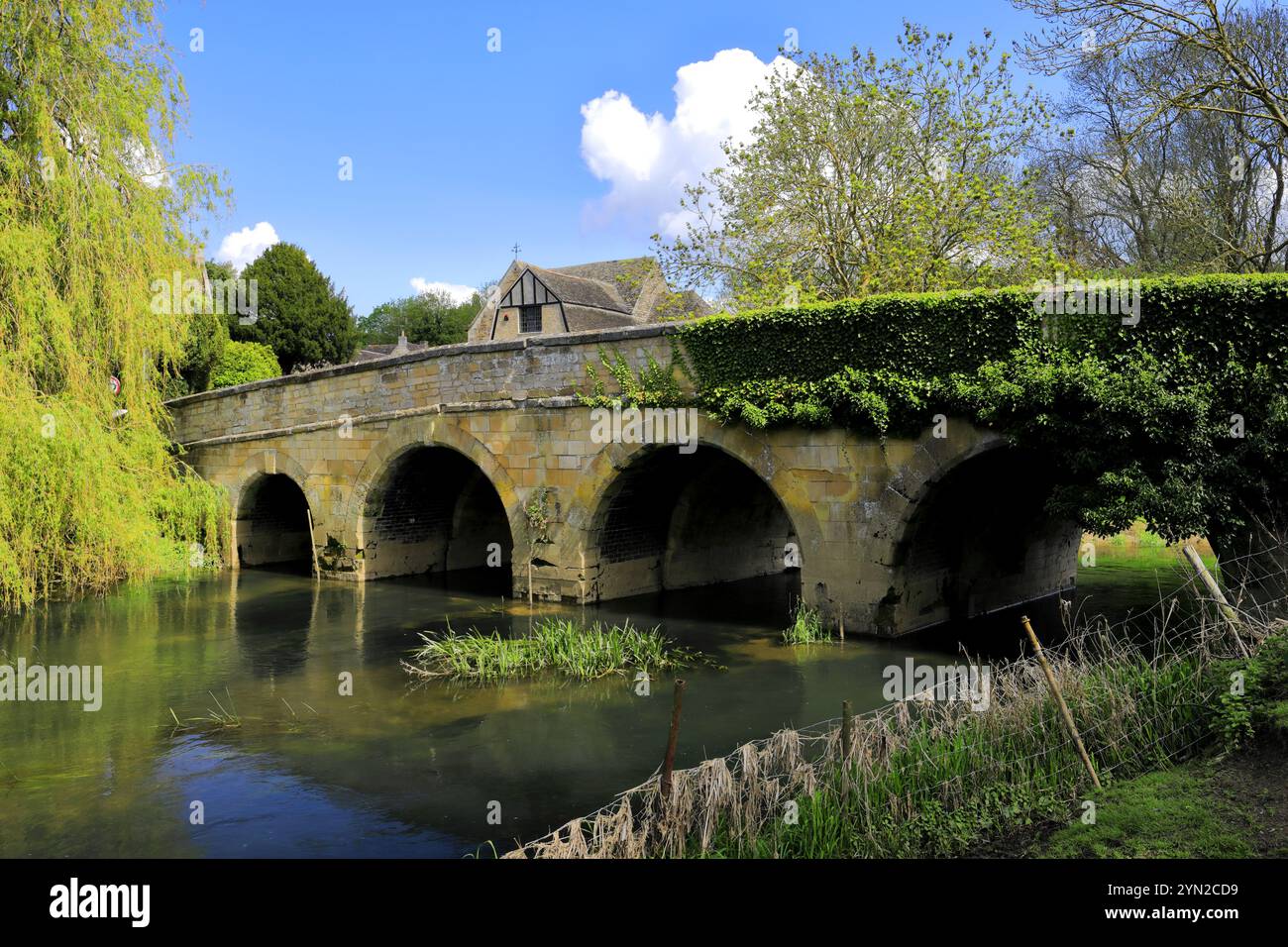 Summer view of the bridge over the river Welland at Duddington village ...