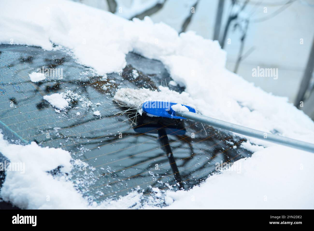 Snow covered car parked on street after snow storm. Side view of small ...