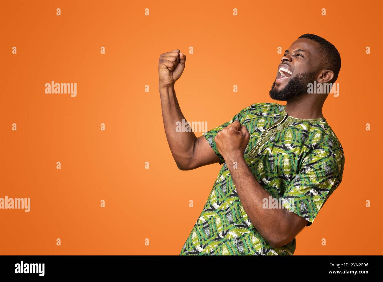Super happy african guy celebrating success over yellow background ...