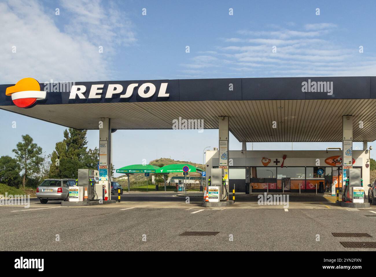 Repsol gas station featuring a convenience store, canopy, and gas pumps ...