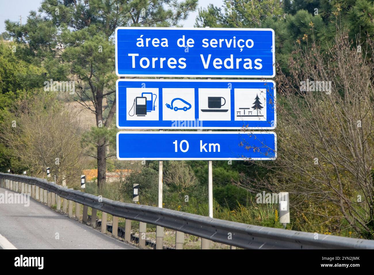 Blue highway sign indicating gas station, electric vehicle charging ...