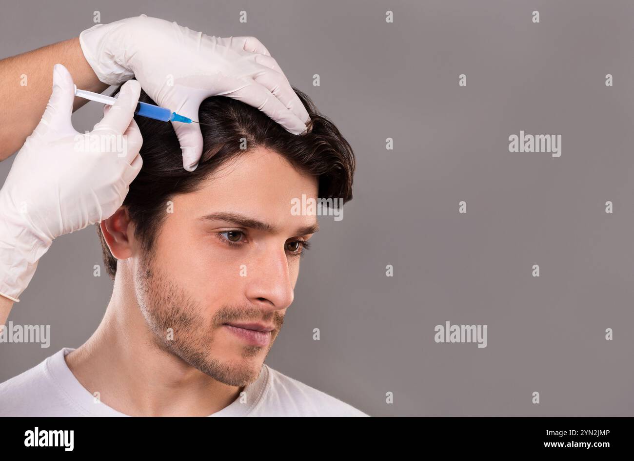 Man with hair loss problem receiving injection in head Stock Photo - Alamy