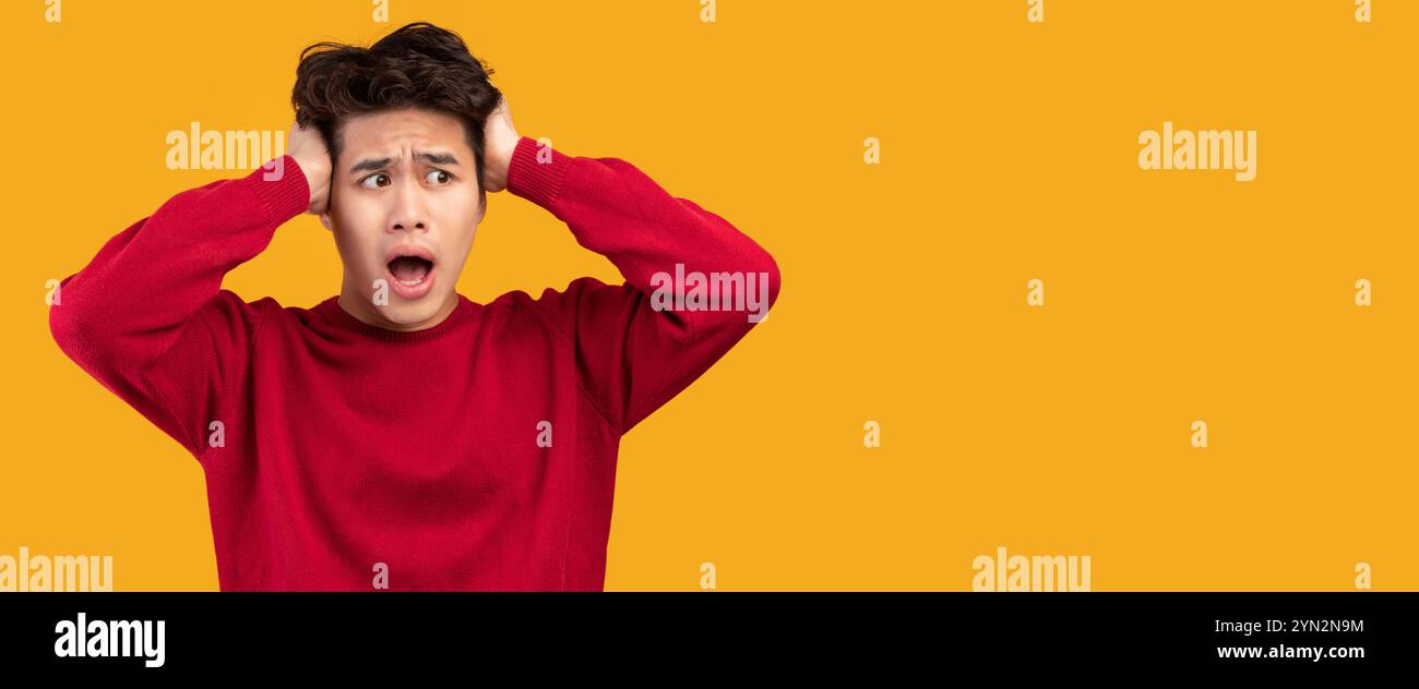 Surprised asian guy seeing shocking advertisement, panorama Stock Photo ...