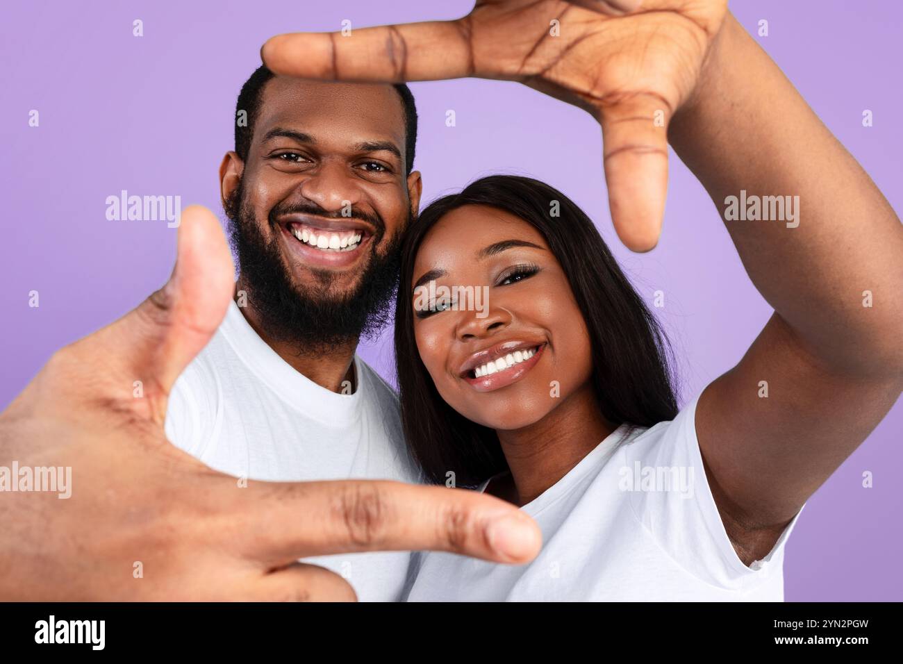 Happy black couple making picture frame with fingers Stock Photo - Alamy