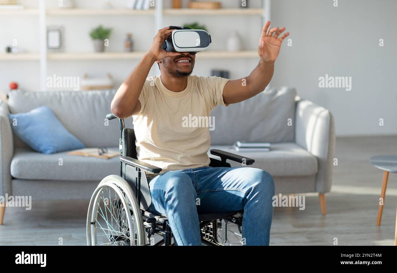 Disabled young black man in wheelchair exploring augmented reality in ...