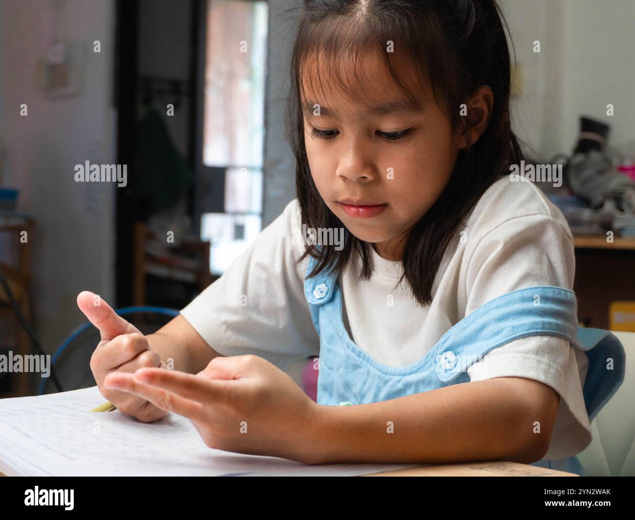 Homeschool Asian little young girl student learning attentively ...