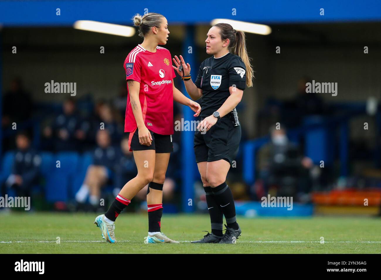 Referee Emily Heaslip speaks to Celin Bizet of Manchester United Women ...