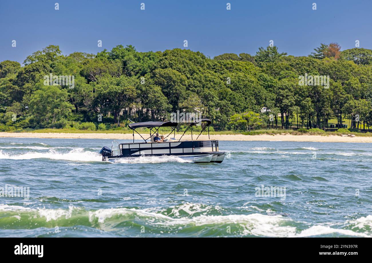 a patoon motor boat on a cruise in choppy water off north haven Stock ...
