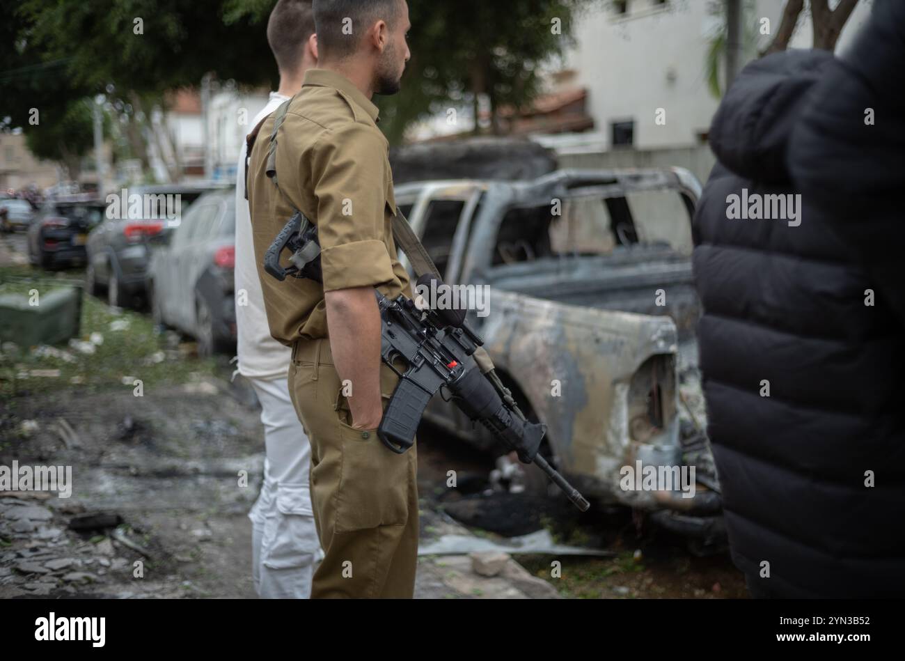 Petah Tikva, Israel. 24th Nov, 2024. People look at the destruction ...