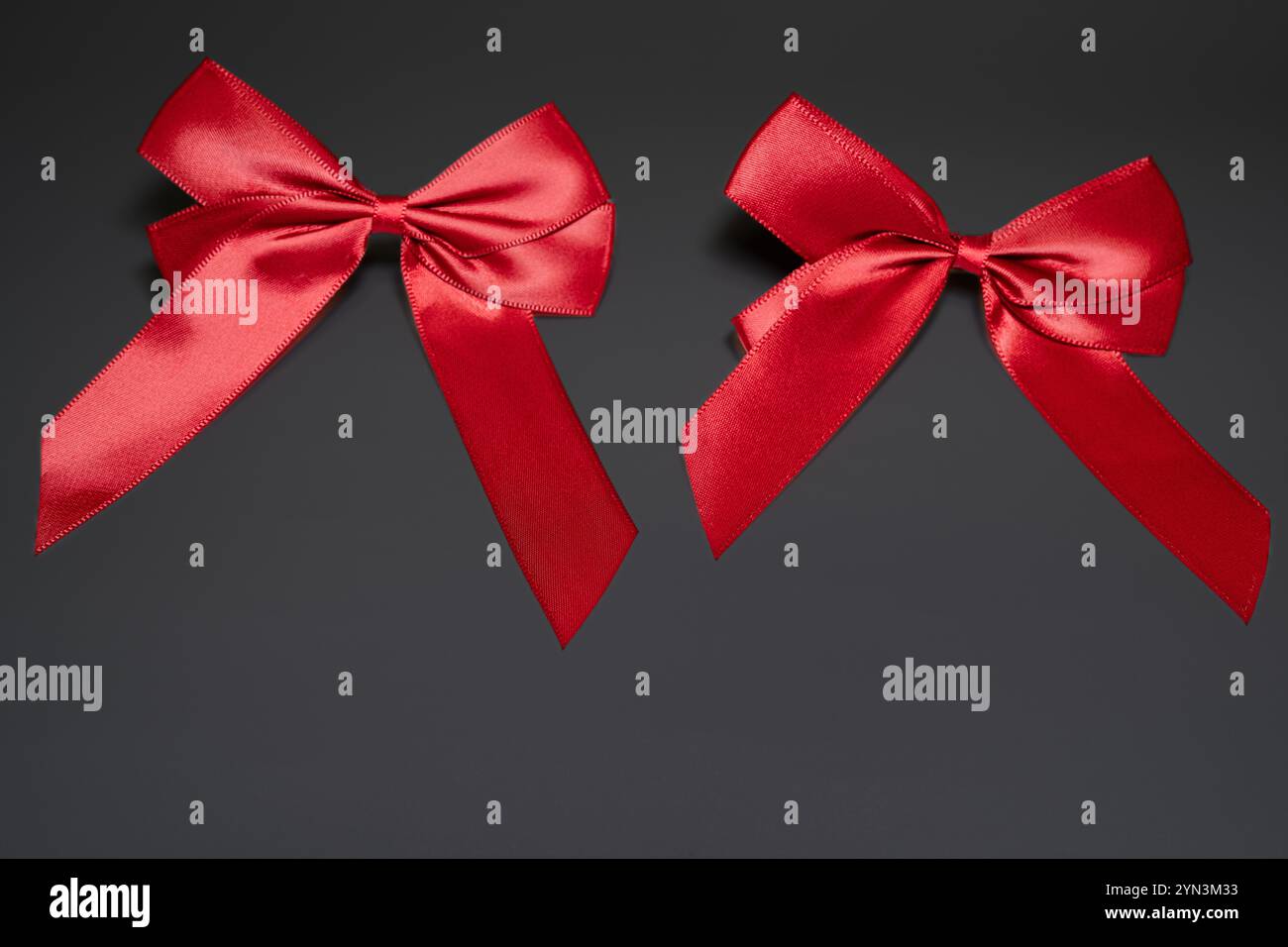 two red ribbons on black background Stock Photo - Alamy