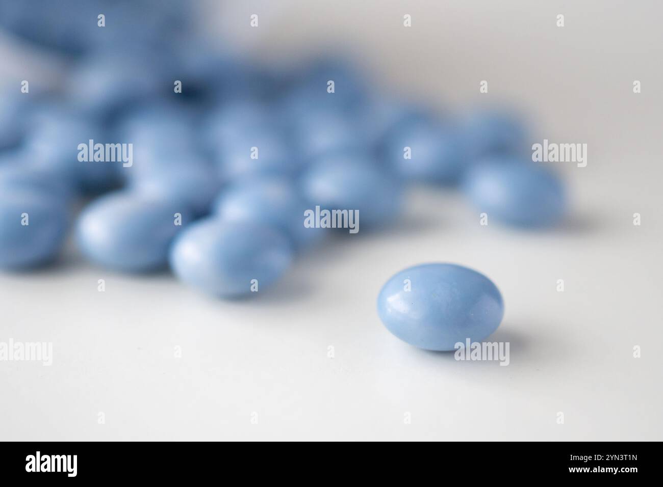 blue medicine pills with bottle on white background Stock Photo - Alamy