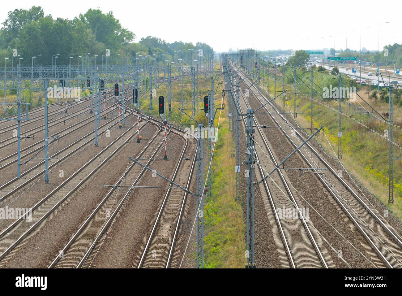 A railway junction featuring multiple sets of tracks, signals, and ...