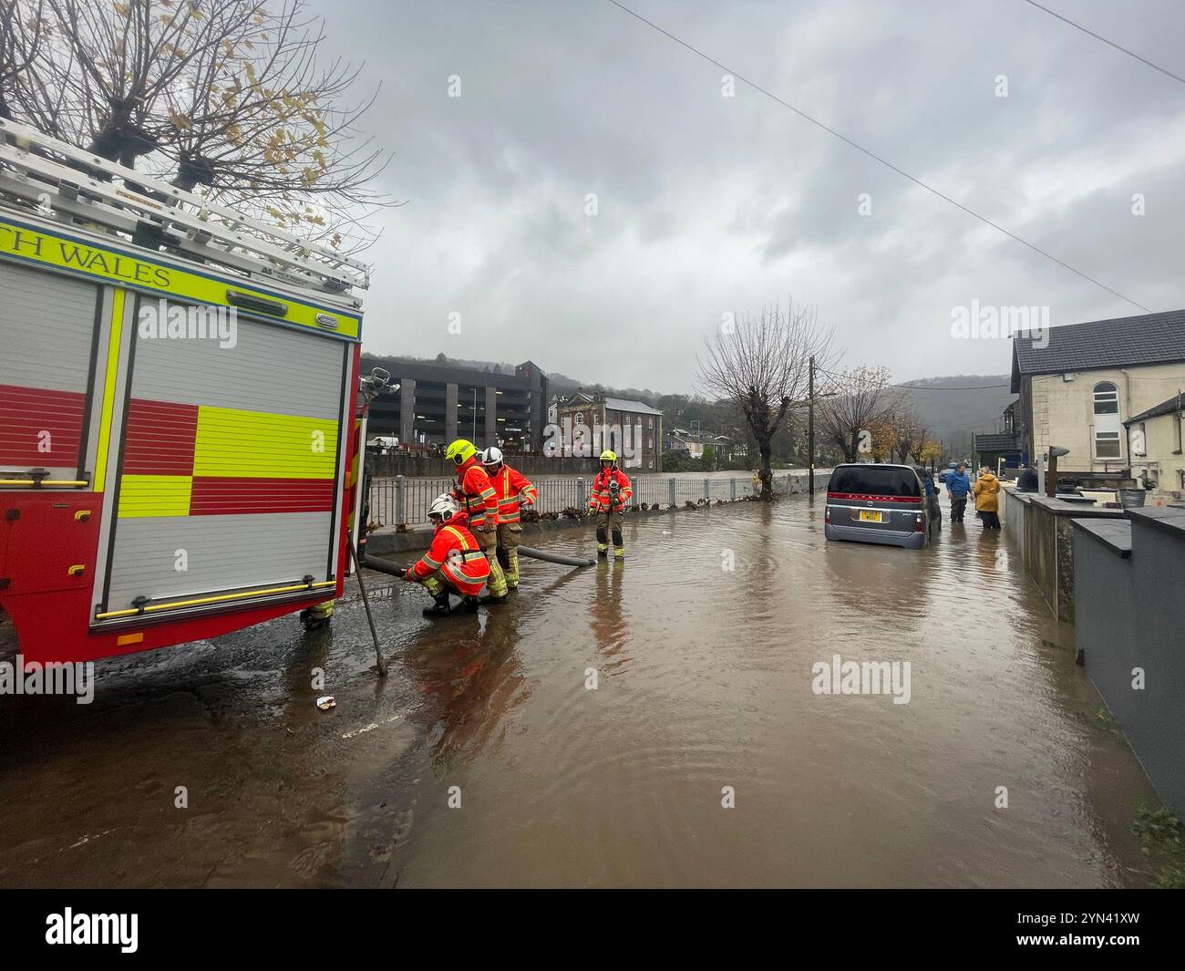 Firefighters pumping water from a street by the River Taff, in ...