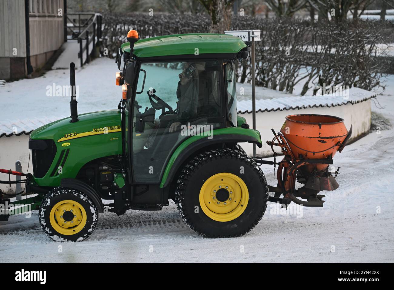 Skånes-Fagerhult, Skåne, Sweden. November 23 2024. Snow plowing tractor ...