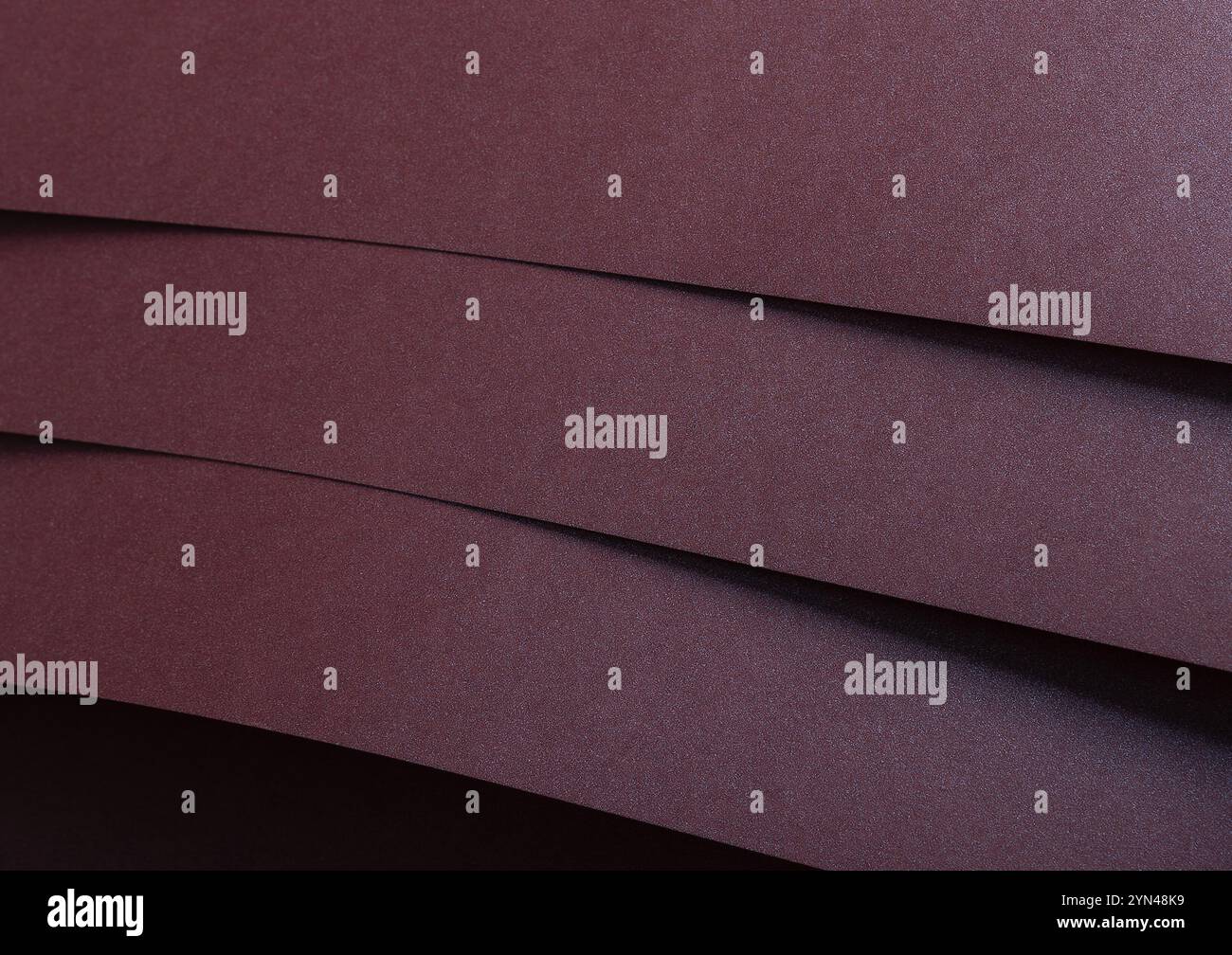 Metallic burgundy paper background with smooth, shimmering lines and a ...