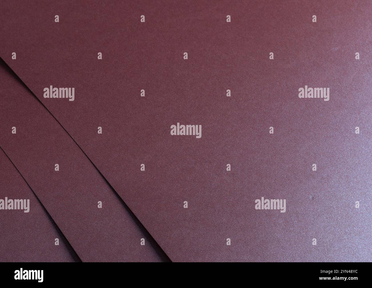 Metallic burgundy paper background with smooth, layered lines and a ...