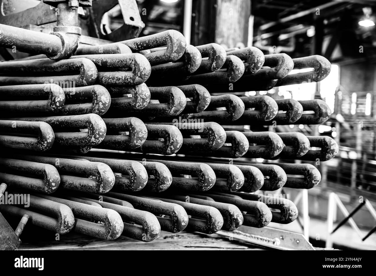 Maintenance being completed on metal piping from boiler coils and ...