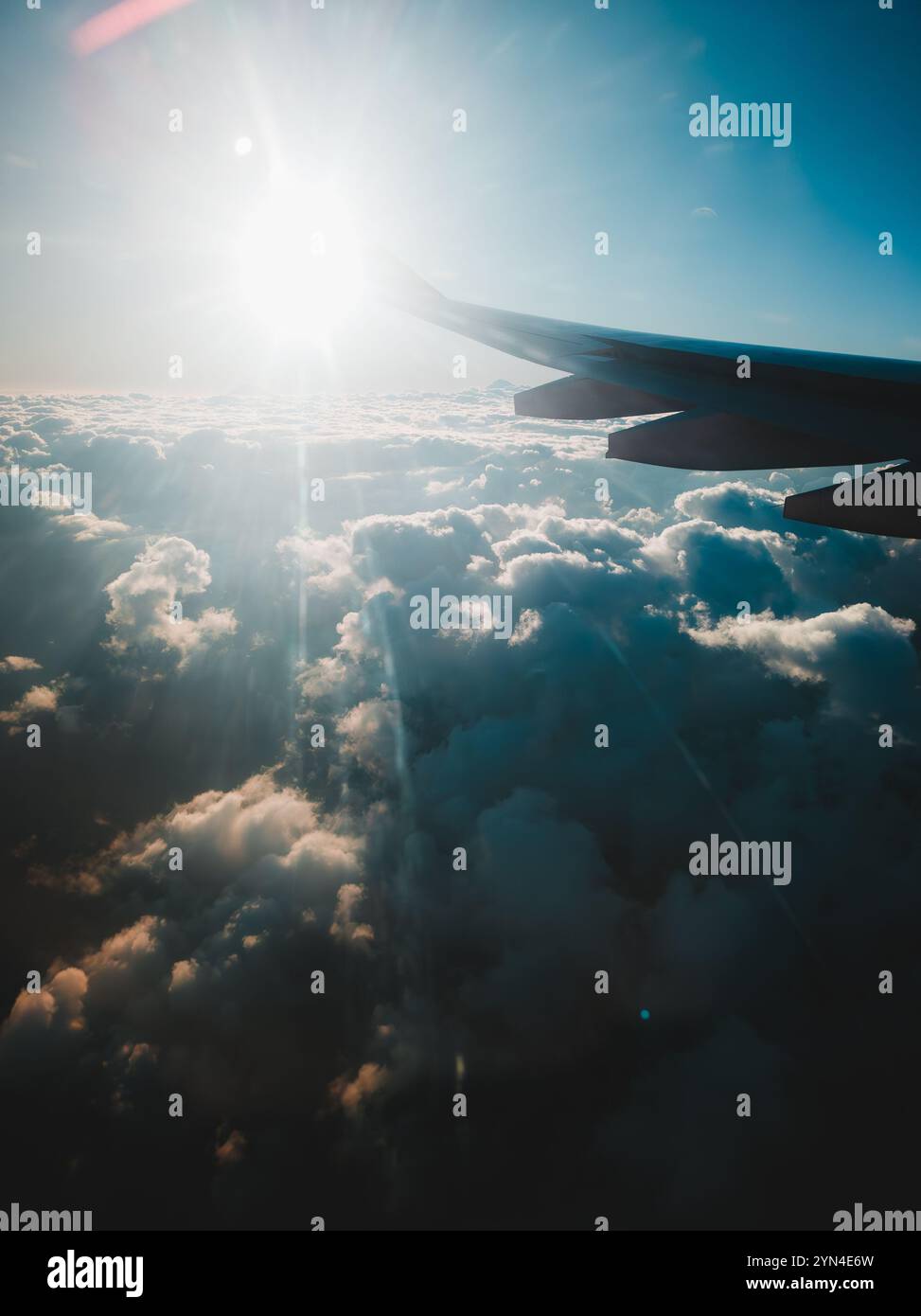 Airplane Wing Illuminated by Radiant Sunlight Above Puffy Clouds ...