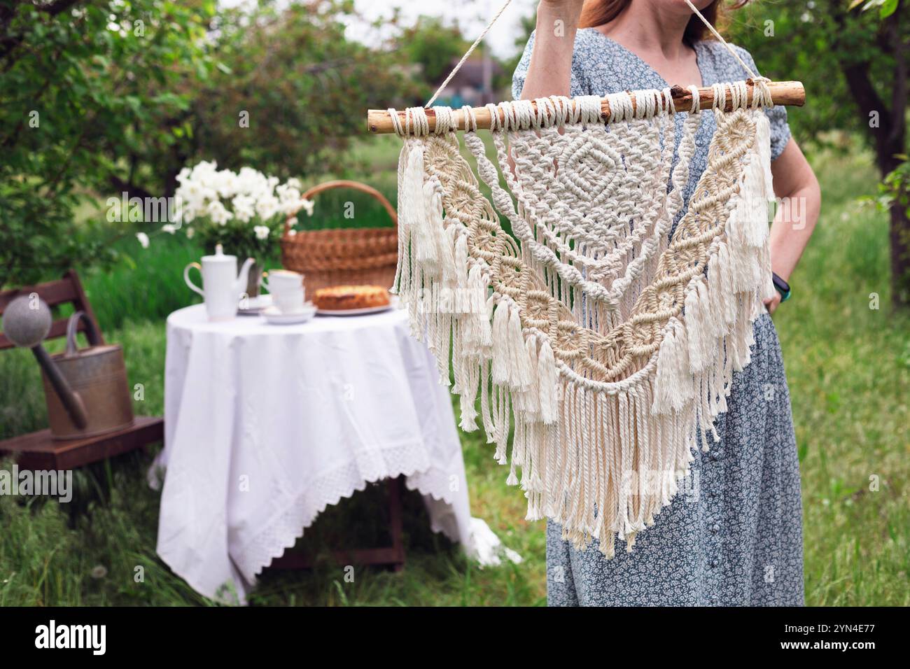creation of a panel from macrame. girl with macram panel in the spring ...