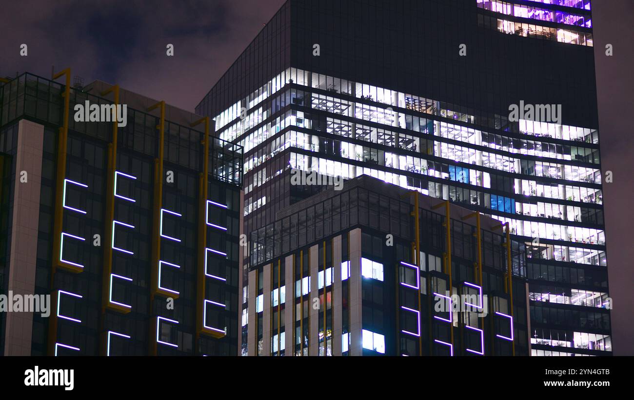 Night architecture, skyscrapers with glass facade. Modern buildings in ...