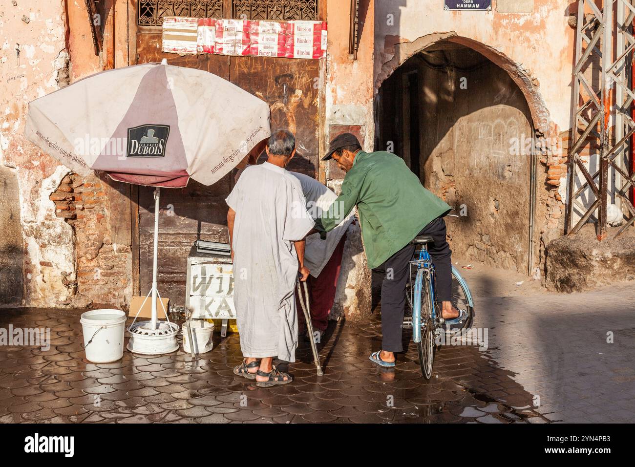 In the medina of Marrakech, in the early morning, men are busy around a ...