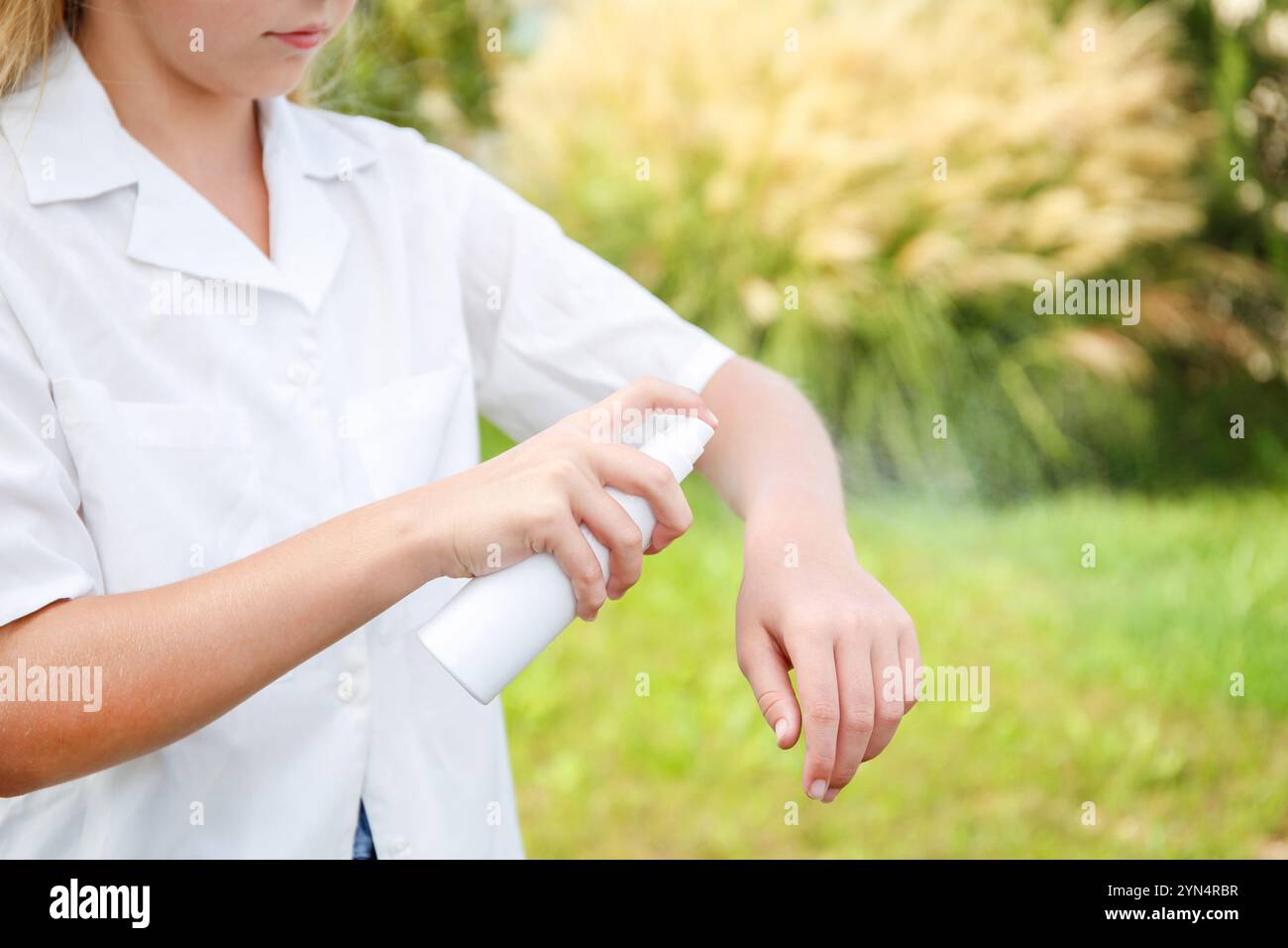A teenager applies insect spray on his hand. The concept of prevention ...