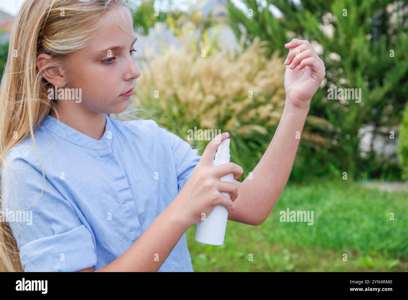 A teenager applies insect spray on his hand. The concept of prevention ...