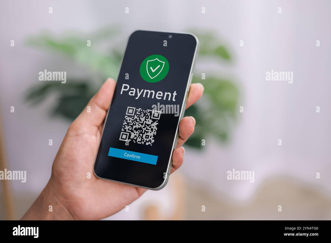 Hands holding mobile phone, Qr code payment or cashless technology concept. Coffee shop ...