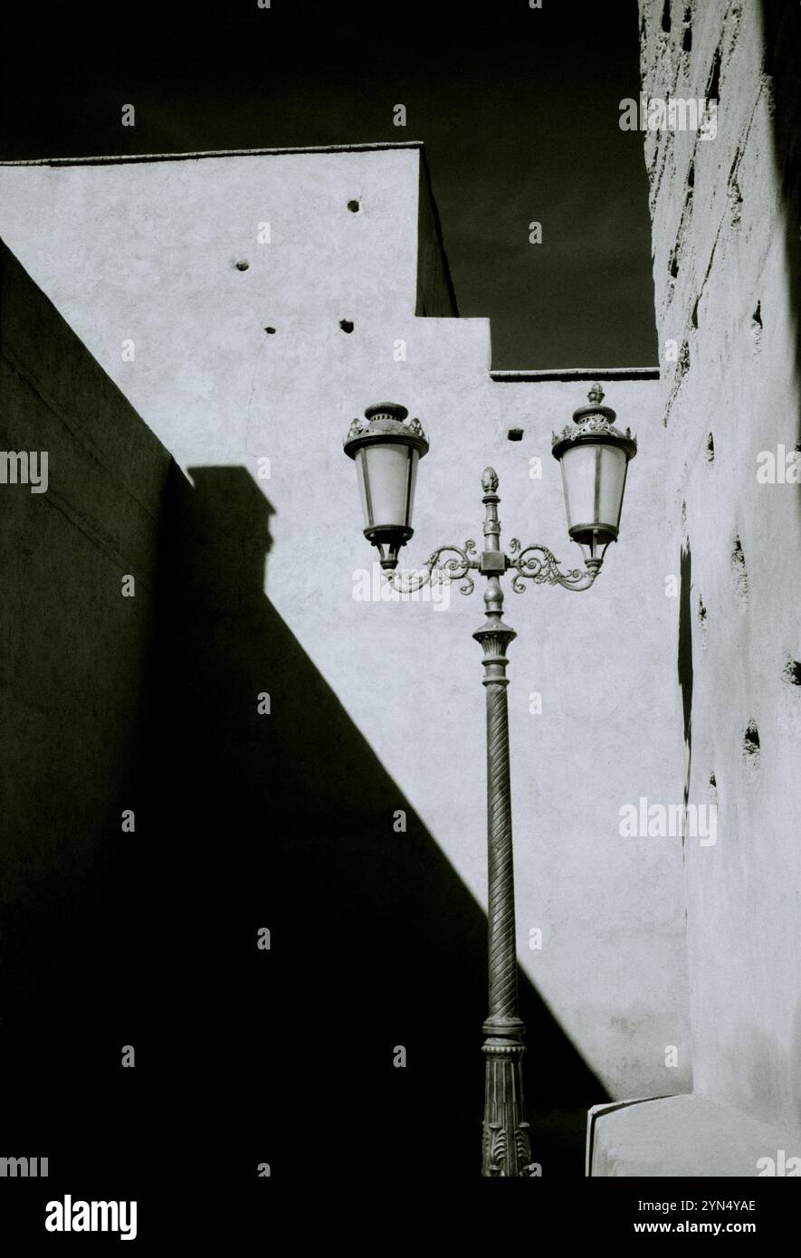Old traditional gaslight against the ancient strong walls of the medina ...