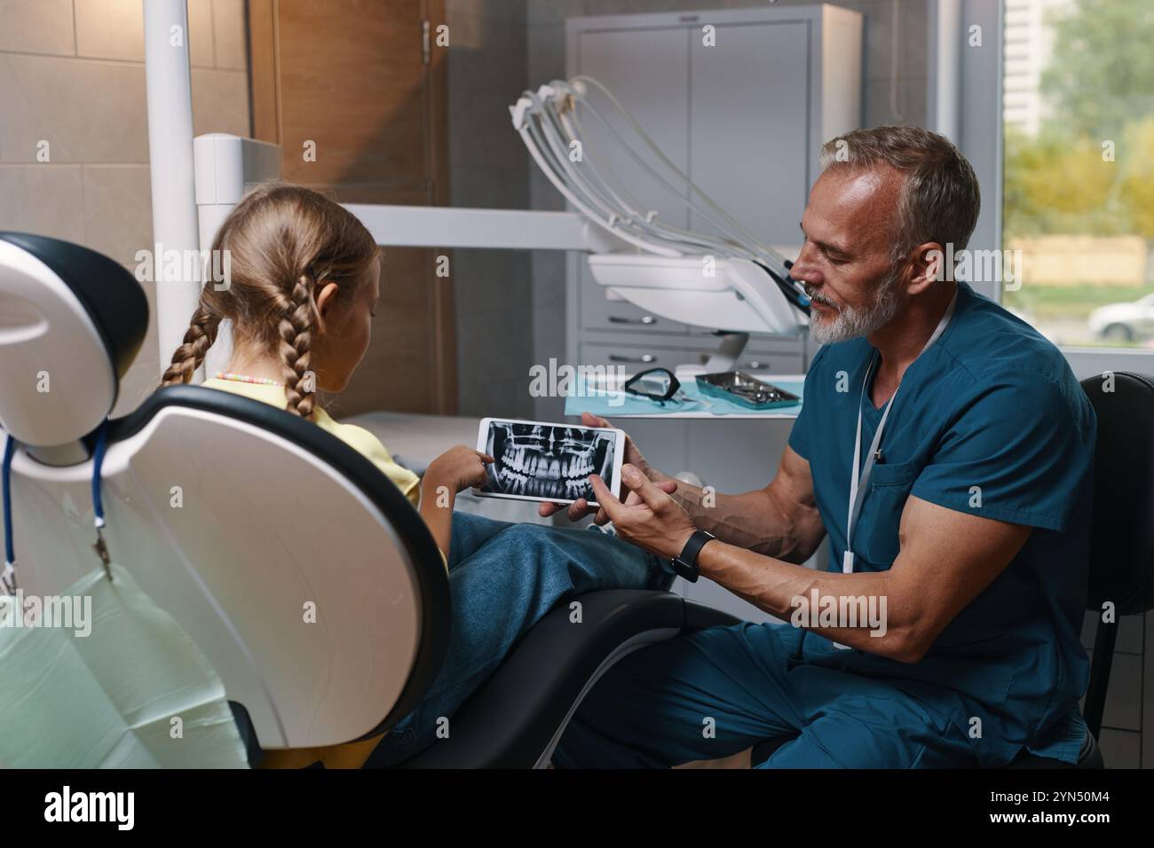 Dentist Explaining Treatment Procedure to Young Patient Stock Photo - Alamy