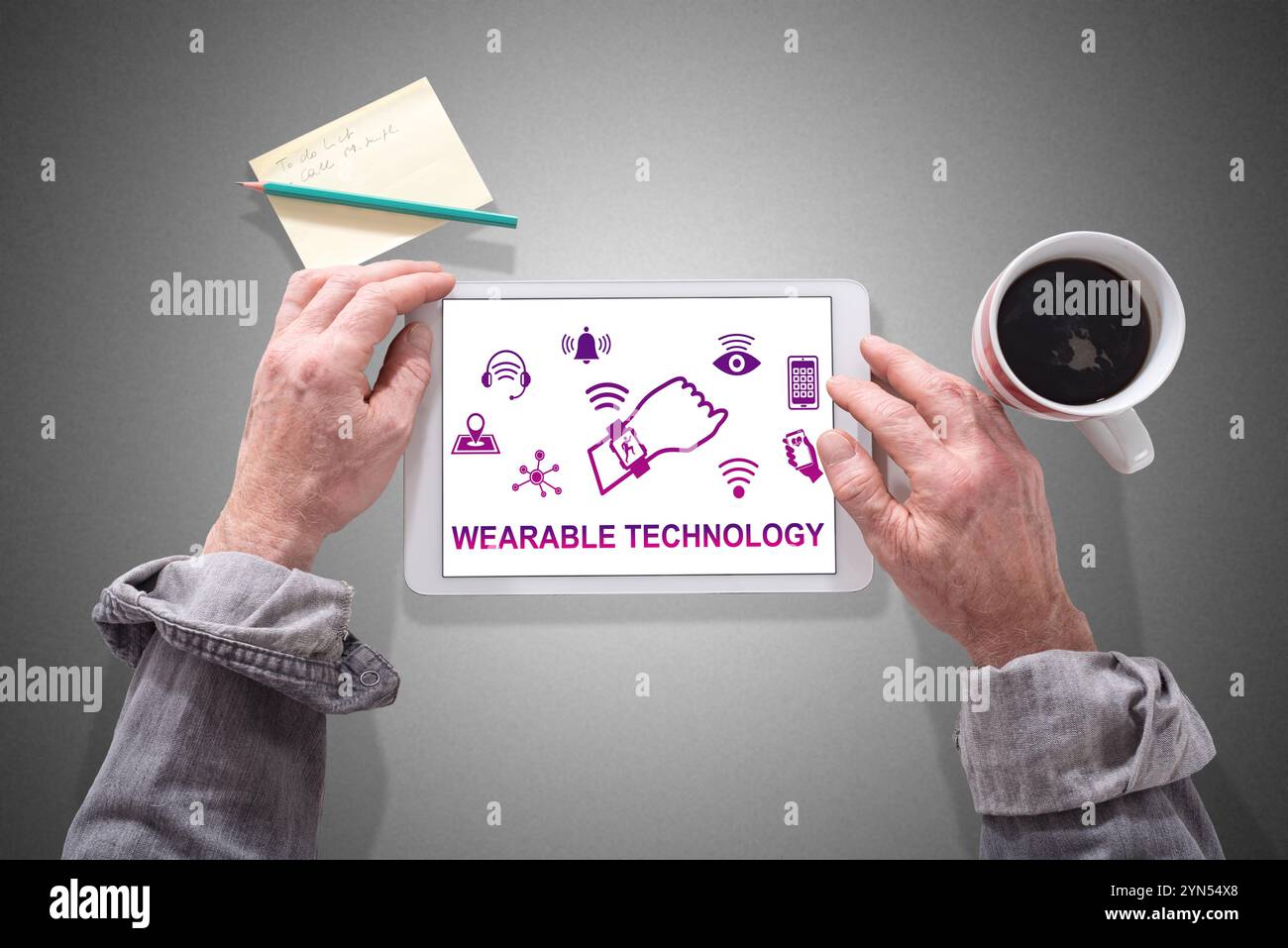Male hands using a tablet showing wearable technology concept Stock ...