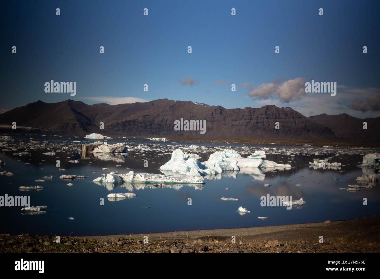 Icelandic sea dotted with floating blue chunks of glacier ice, creating ...
