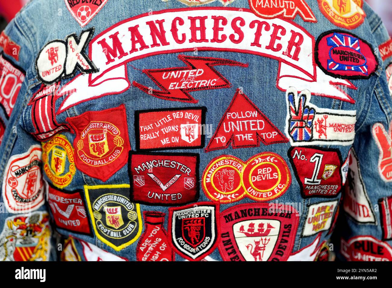 A Manchester United fan with patches sewn into his jacket during the ...