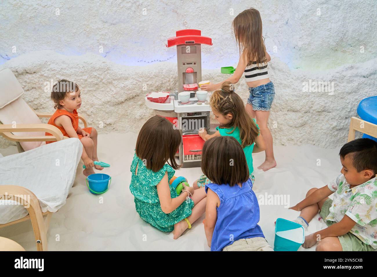 Group of children playing in a salt cave during halotherapy session ...