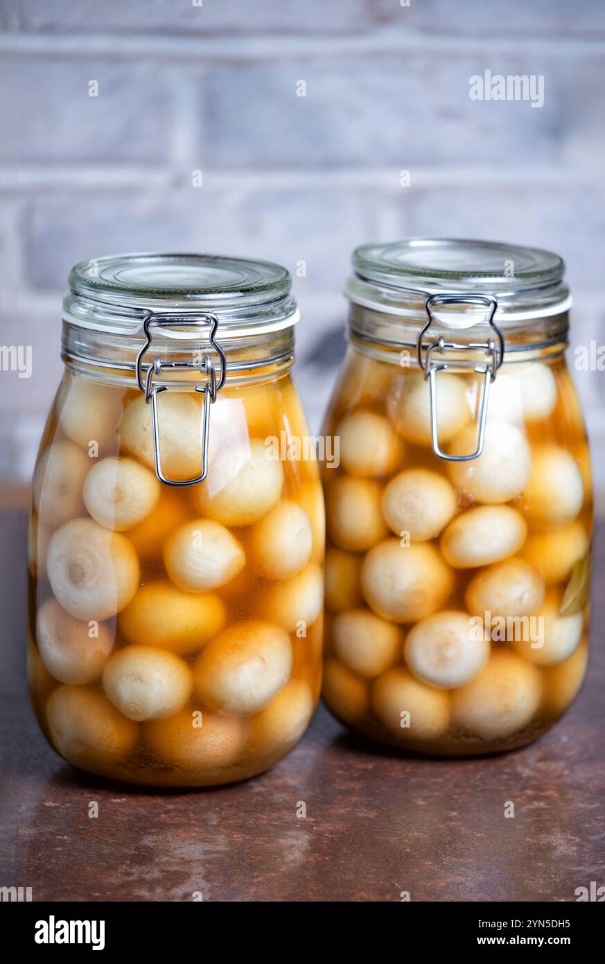 Jars of traditional homemade pickled onions preserved in spiced vinegar ...