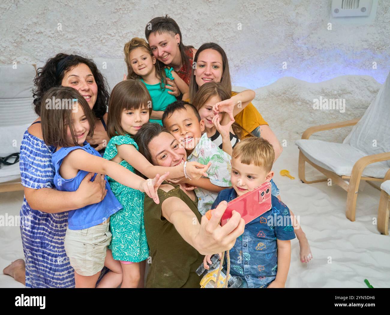 Group of mothers and children taking a selfie in a salt cave during ...