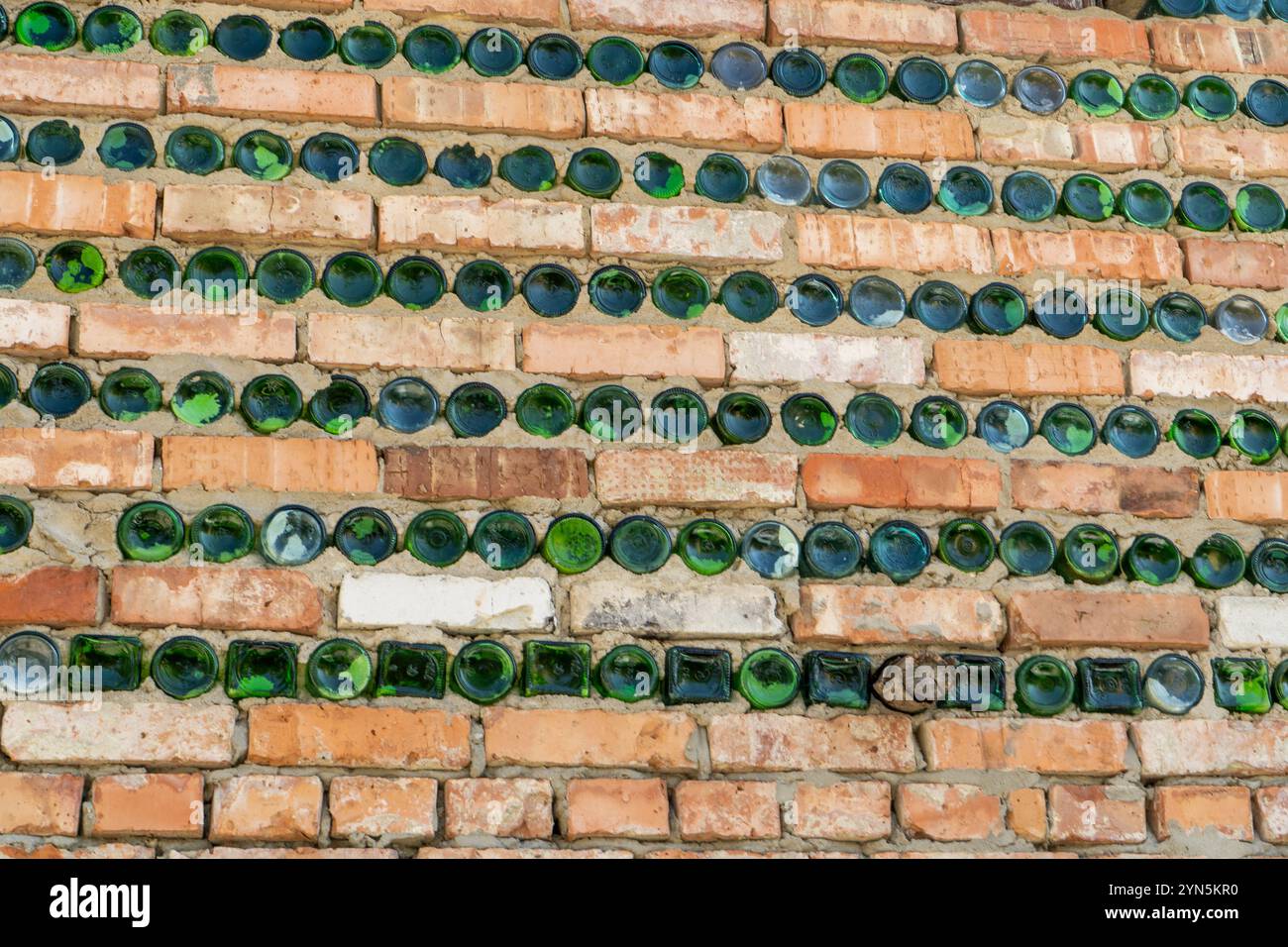 The wall of the house is made of bricks and glass green bottles. Zero ...