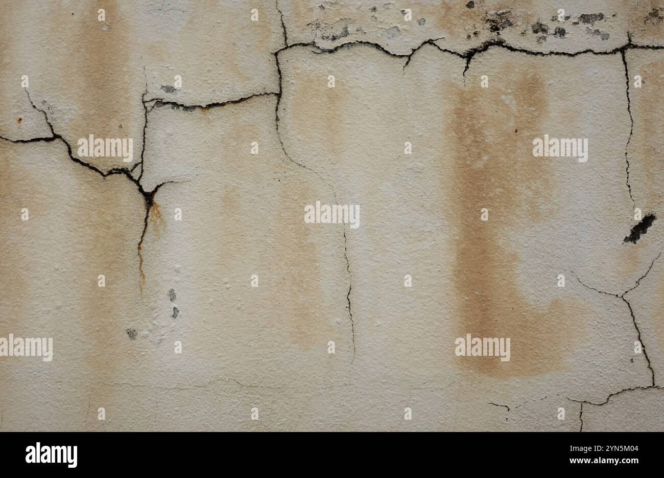 Wall with visible cracks and peeling paint highlighting wear and tear ...