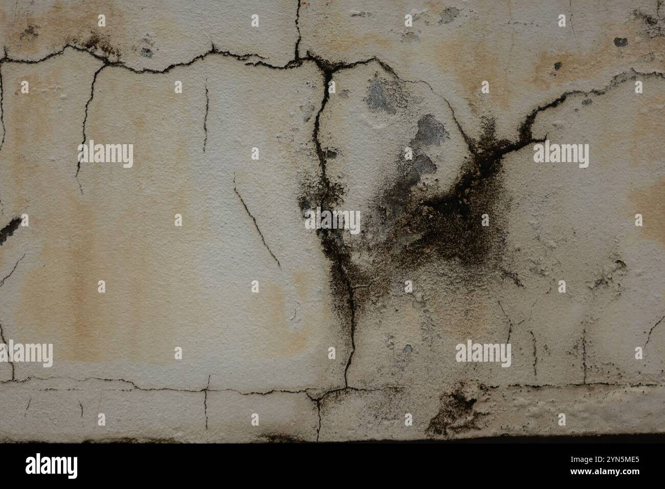 Wall with visible cracks and peeling paint highlighting wear and tear ...