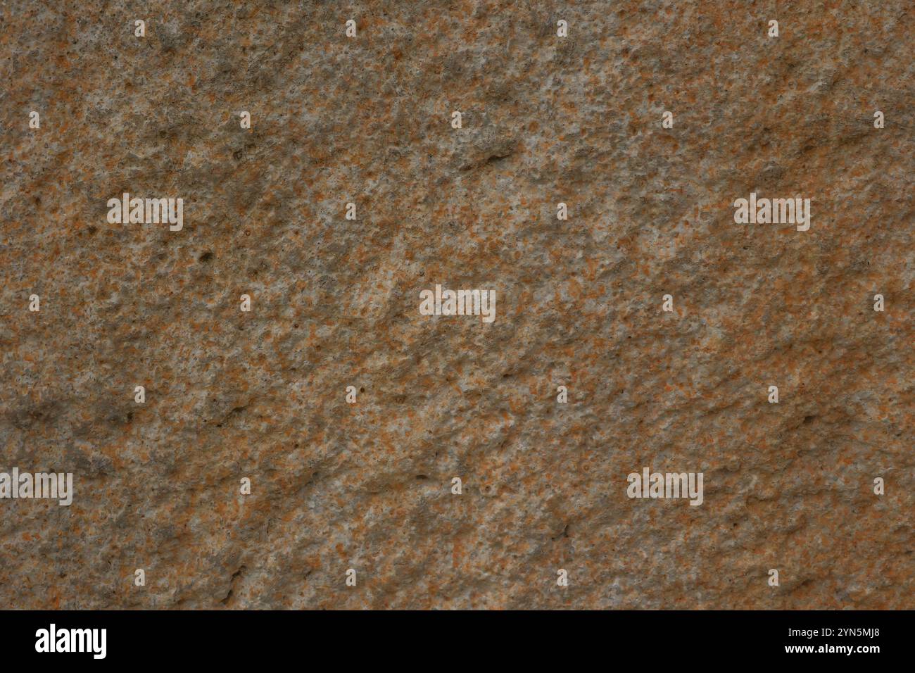 Close-up of a natural stone texture with earthy tones of orange and ...