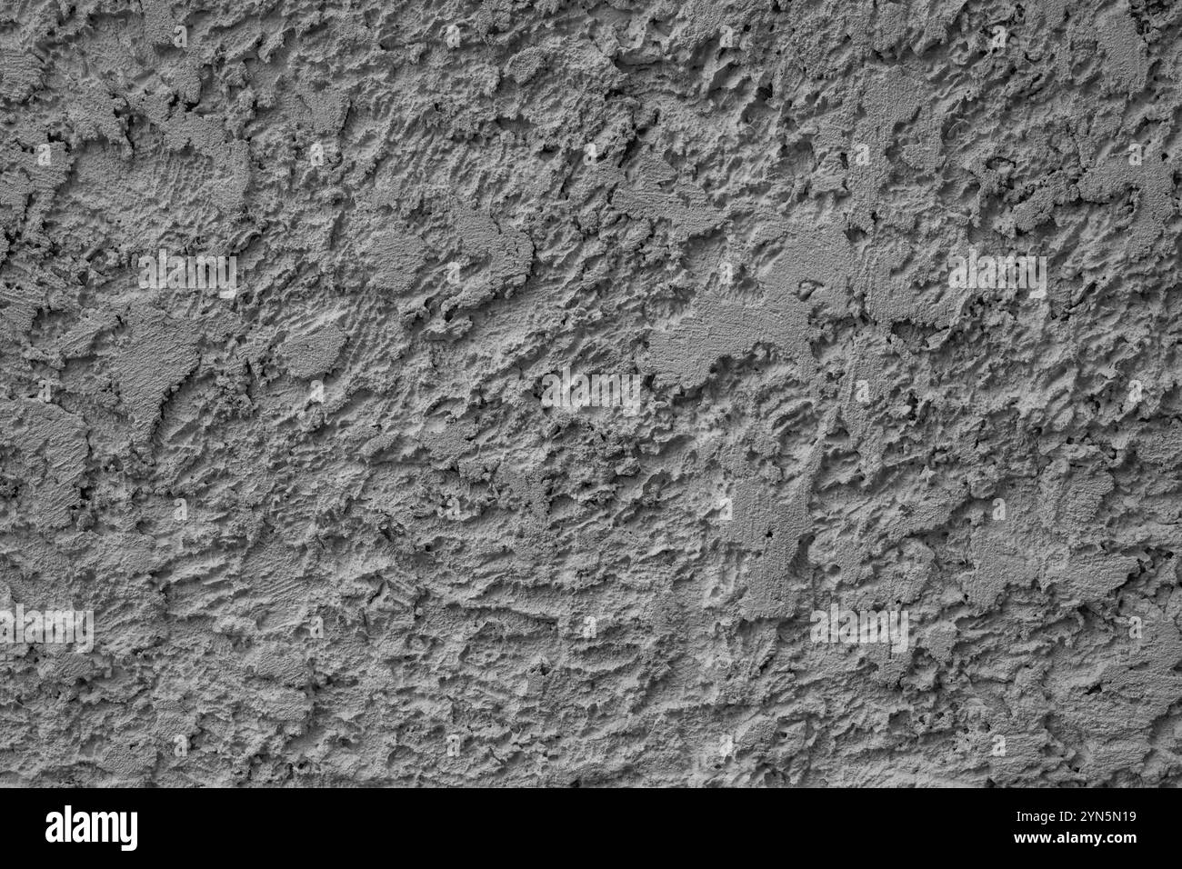 Close-up of rough textured concrete surface in grayscale. A perfect abstract background for ...