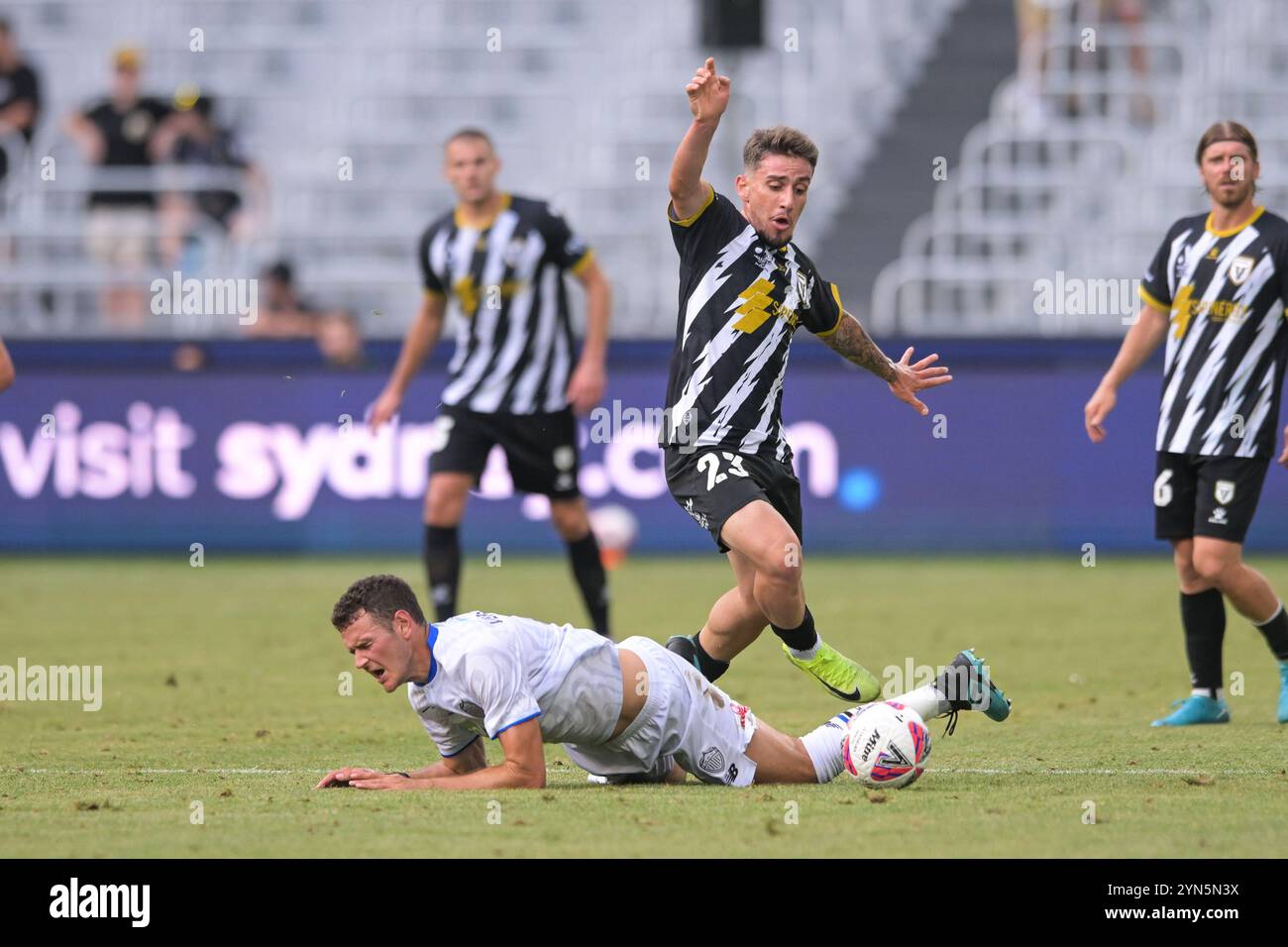 Frans Deli (back) of Macarthur FC and Louis Verstraete (front) of ...