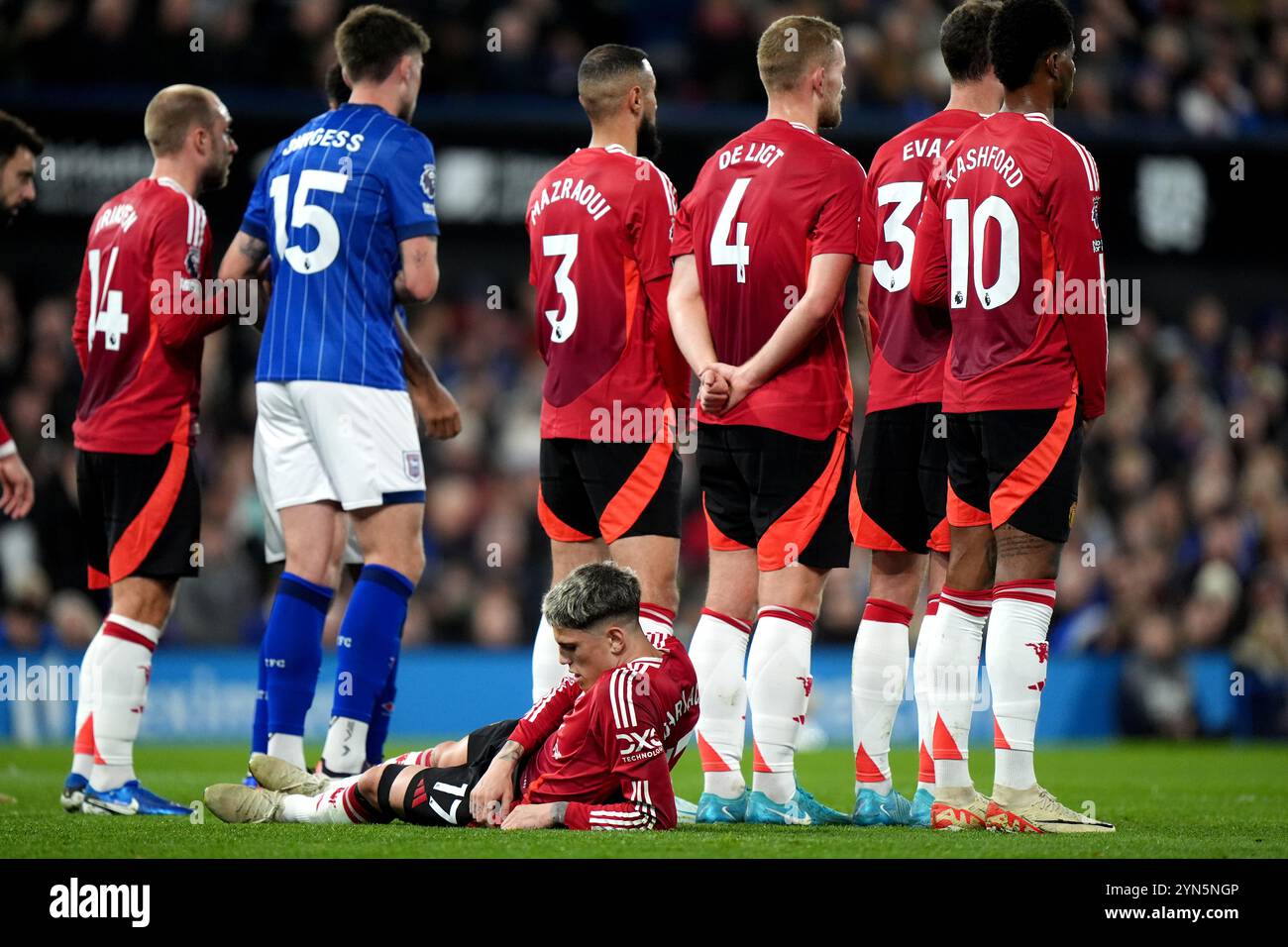 Manchester United's Alejandro Garnacho lies on the floor before a free ...