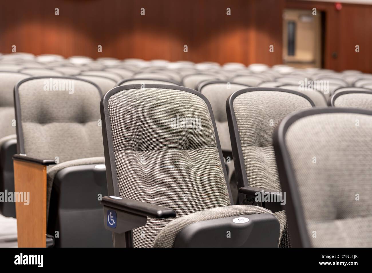 Close up photo of empty light brown, tan theater, auditorium seats ...