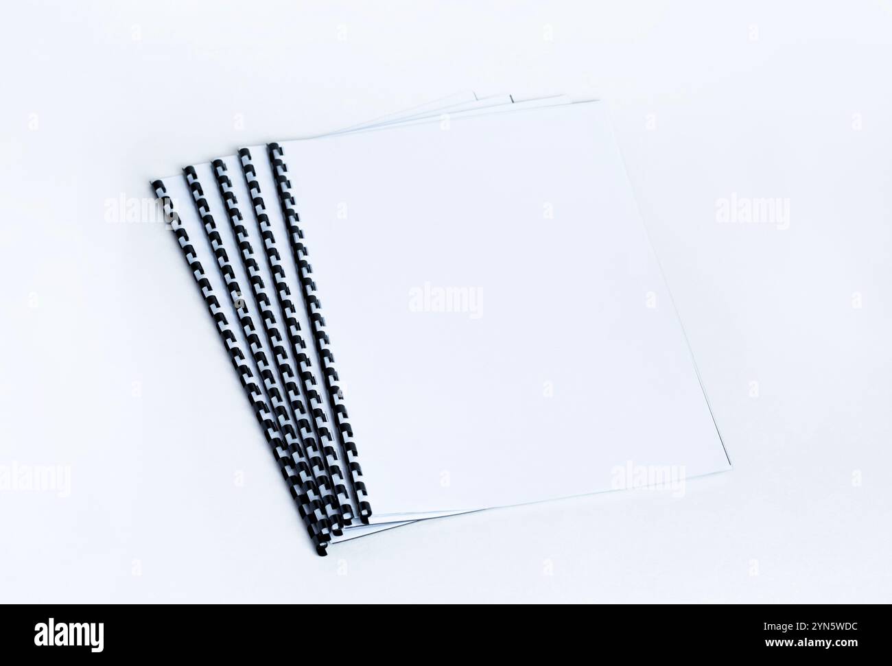 Binded documents with plastic spiral on white background Stock Photo ...