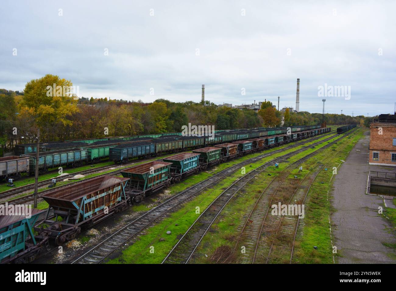 Industry, transport, wide metal railway lines with trains and large ...